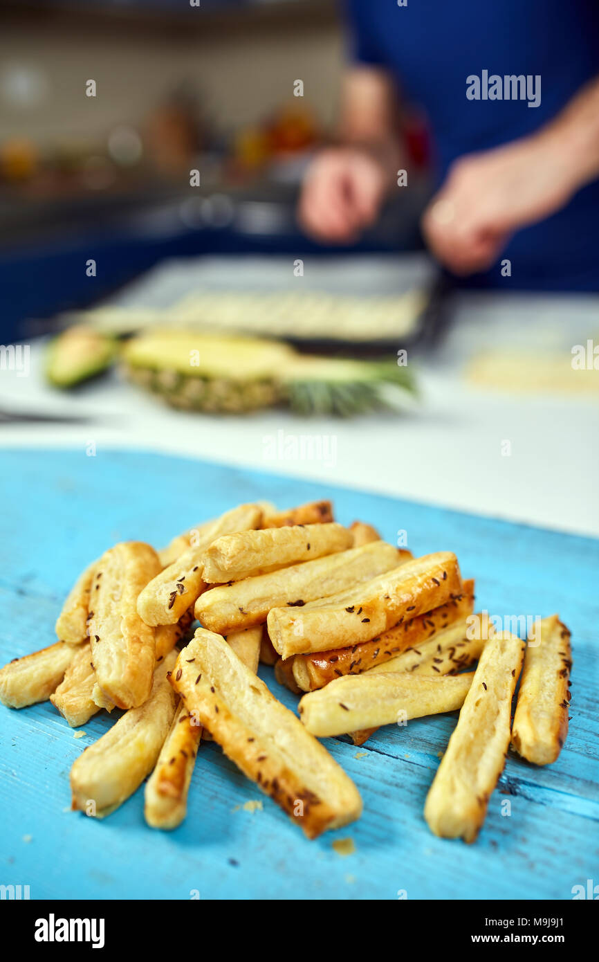 Man preparing cheese crackers at home in the kitchen Stock Photo - Alamy