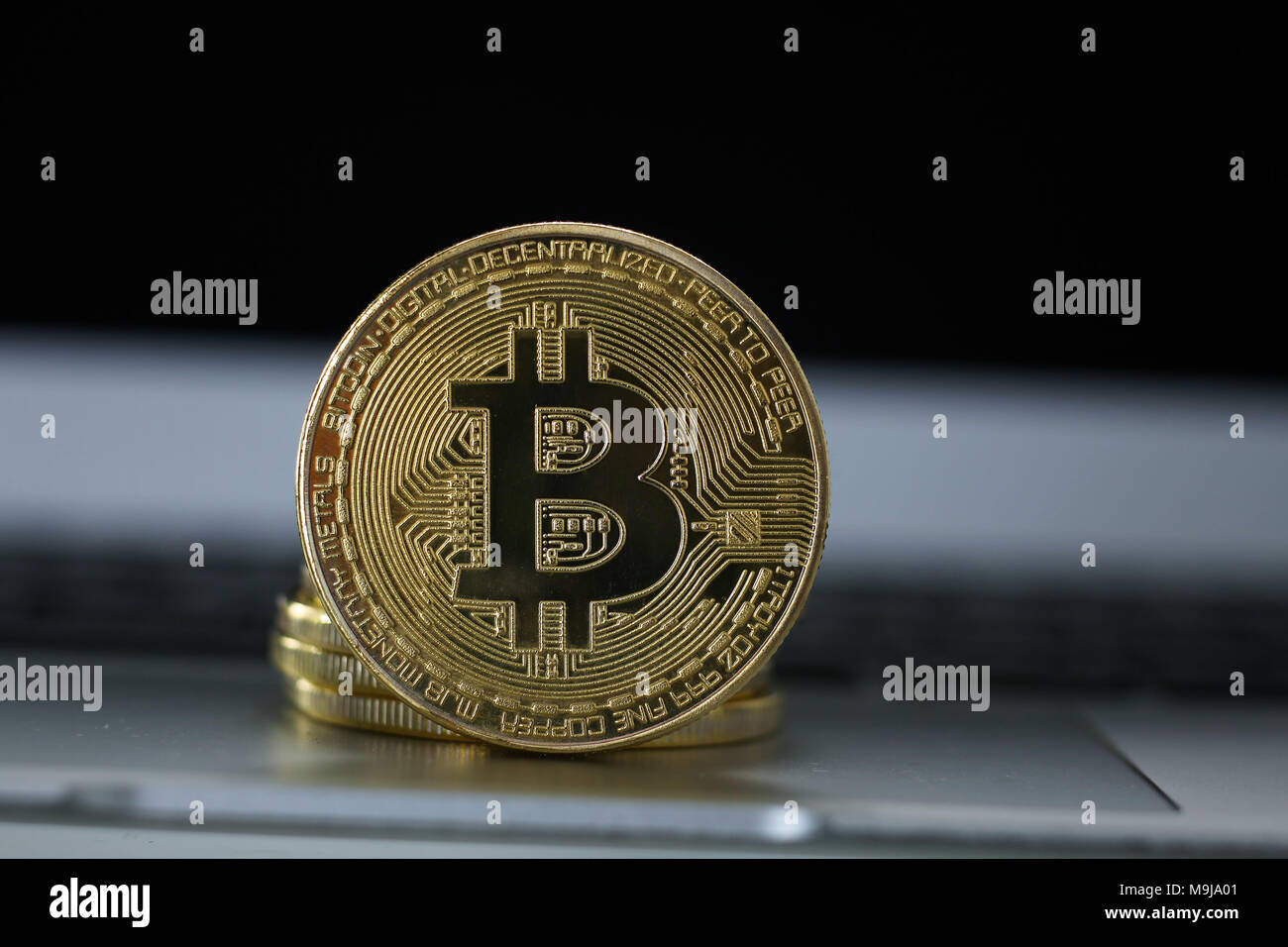 Golden Bitcoin facing the camera in sharp focus, close-up. Virtual ...
