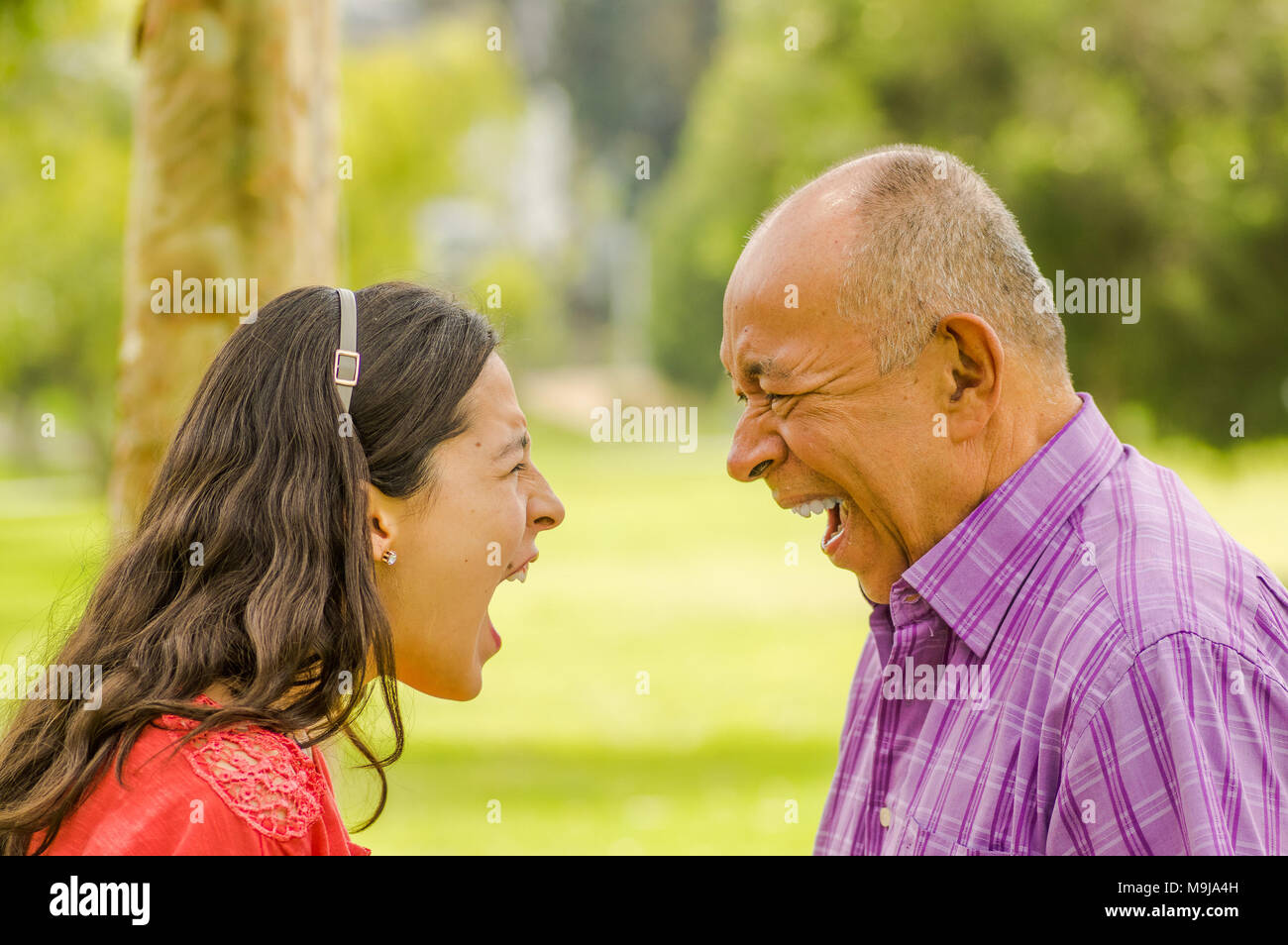 Close up of daughter and father arguing and screaming each other at ...