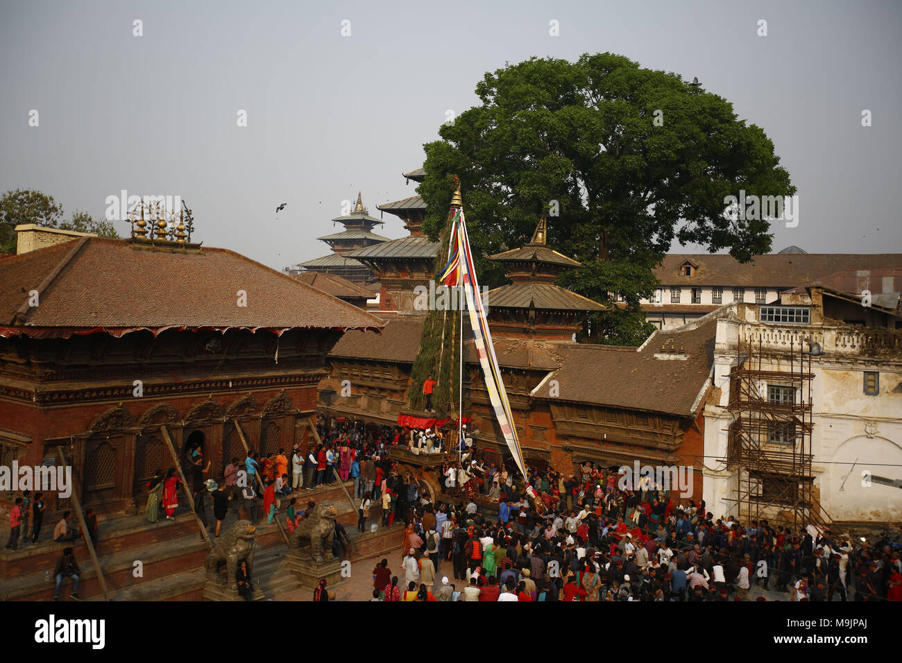 Kathmandu, Nepal. 27th Mar, 2018. Devotees pull a 28-foot-high chariot ...