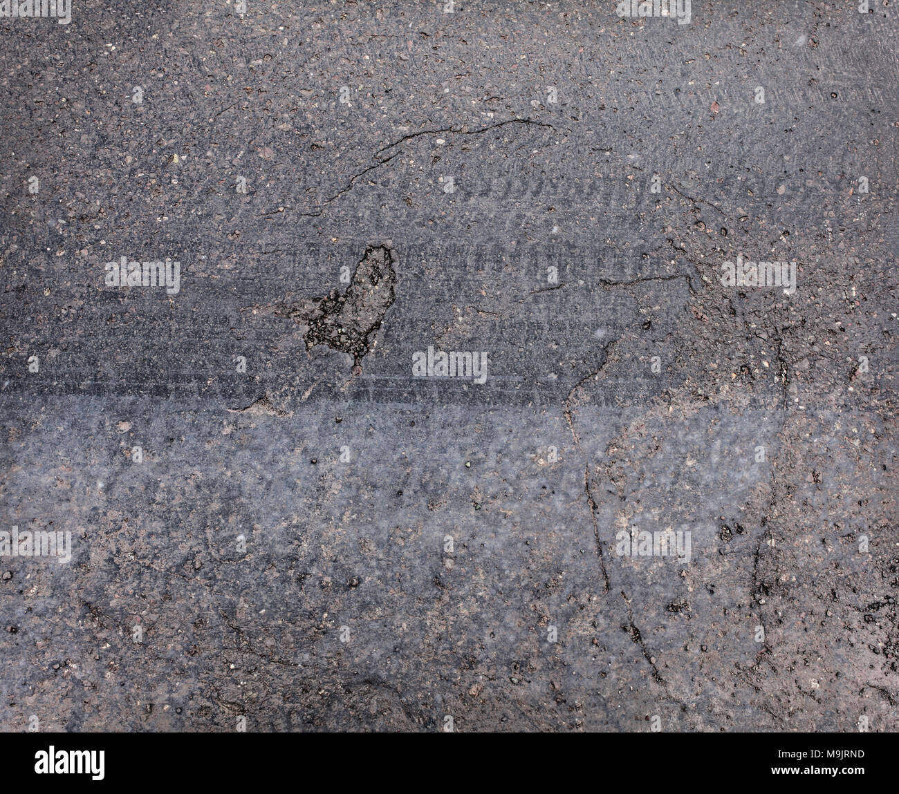 Old worn asphalt road with cracks texture Stock Photo - Alamy
