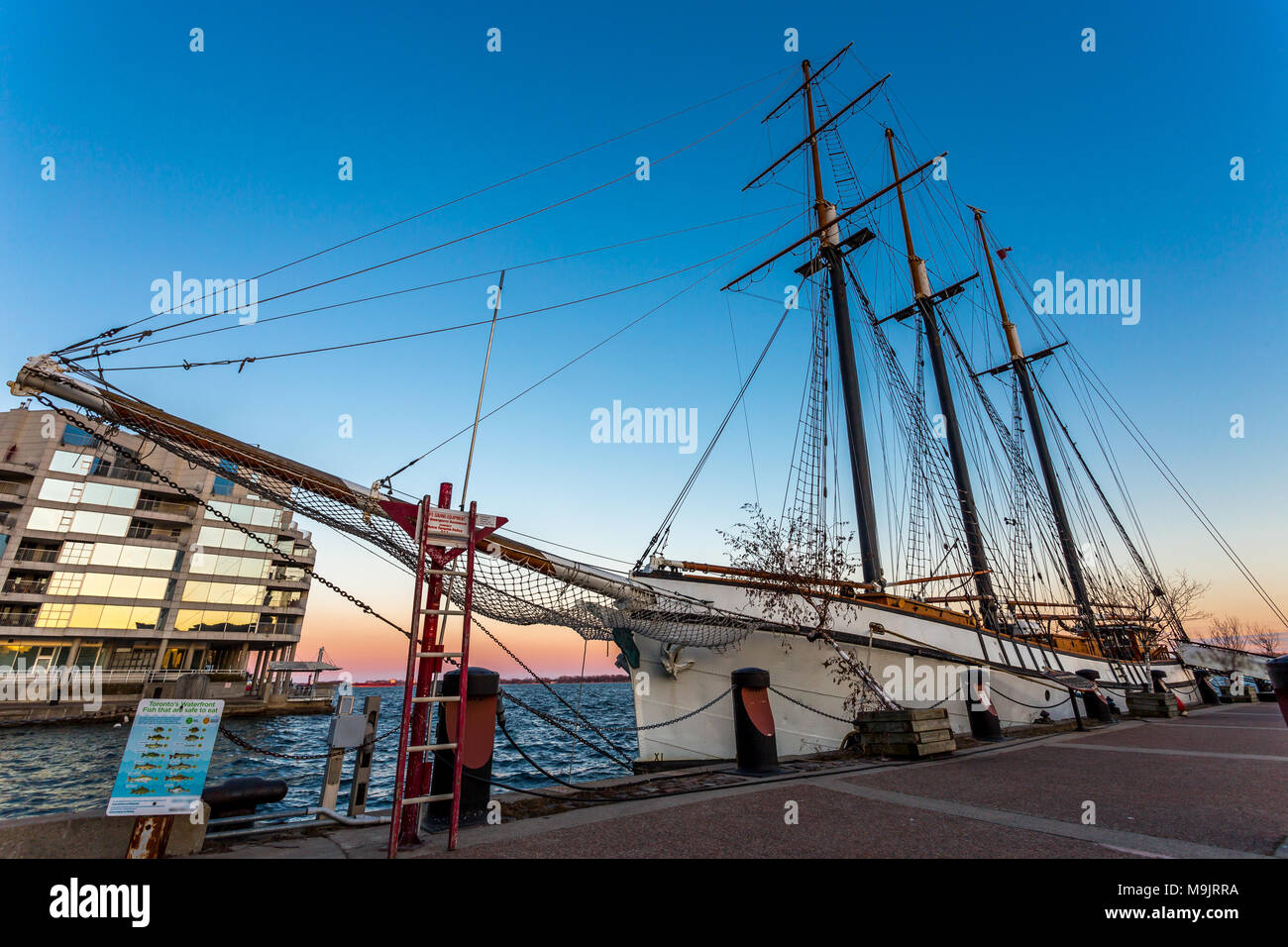 Tall ship parked at Toronto Harbourfront with a dusky sky as the ...