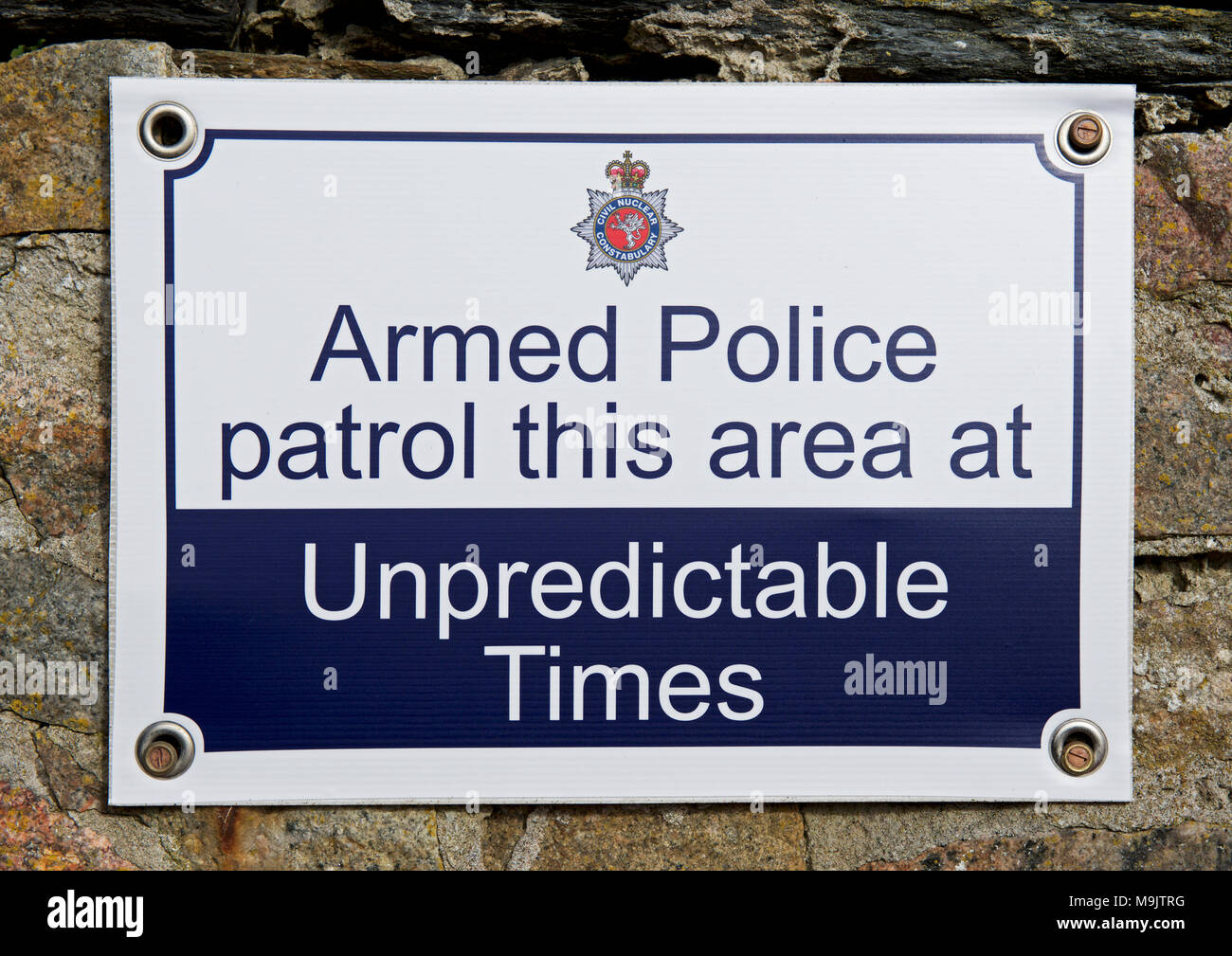 Sign: Armed police patrol this area at unpredictable times, England UK ...