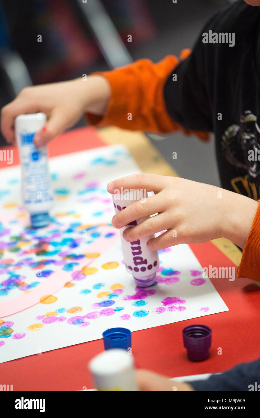Child making art in school classroom Stock Photo - Alamy