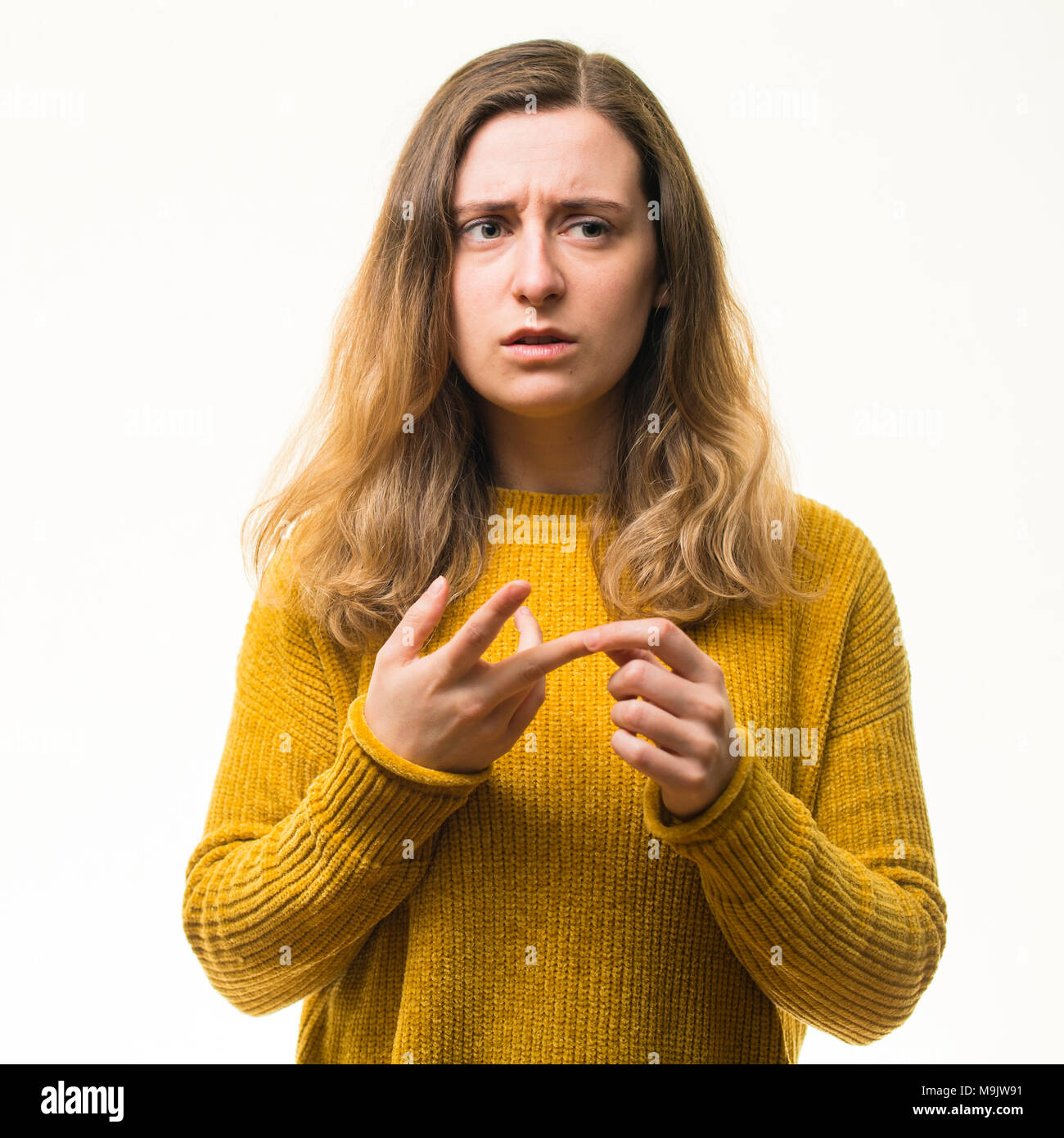Thinking things through: A young Caucasian woman girl wearing a yellow ...