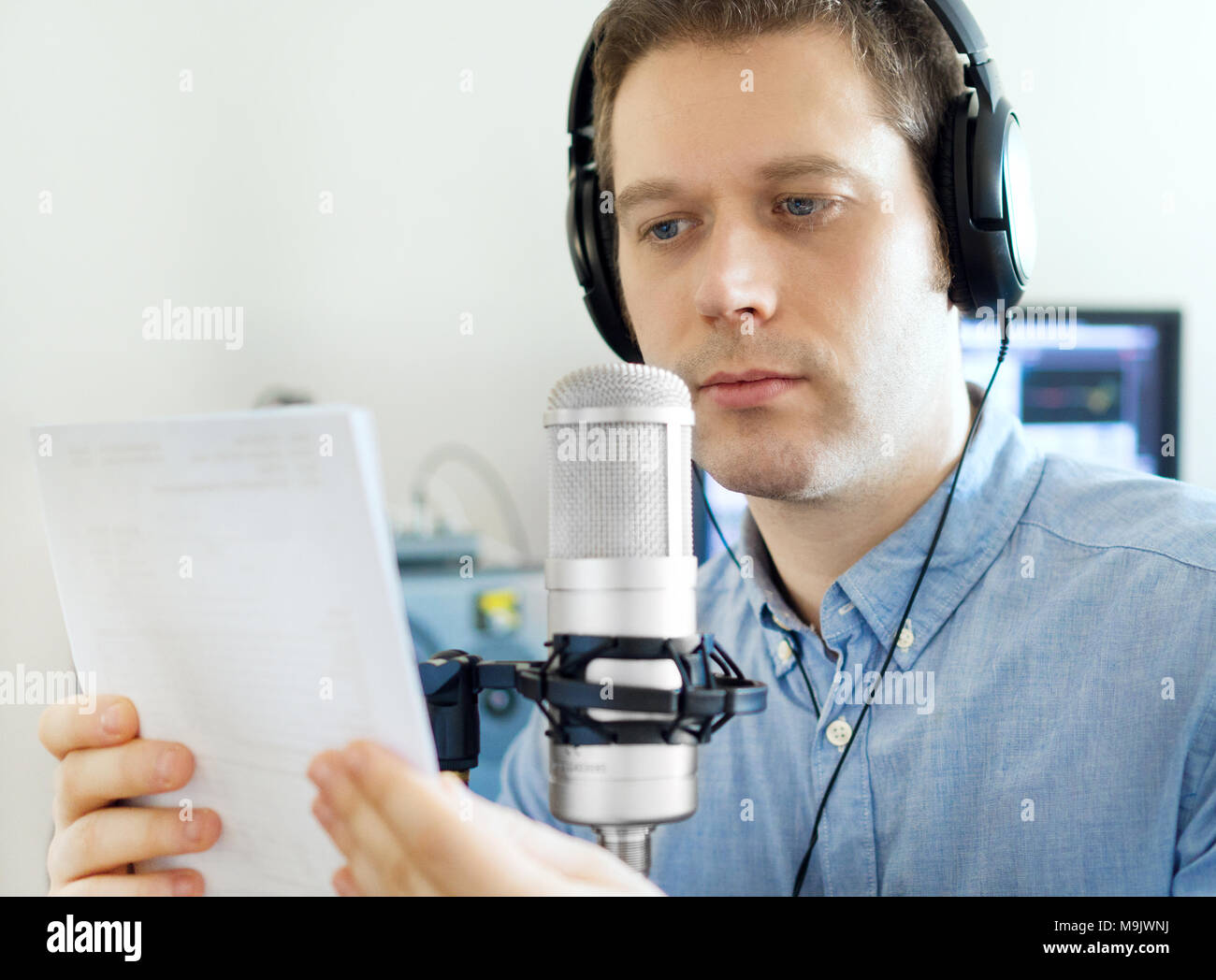 Handsome man recording an advertisement on the radio station Stock ...