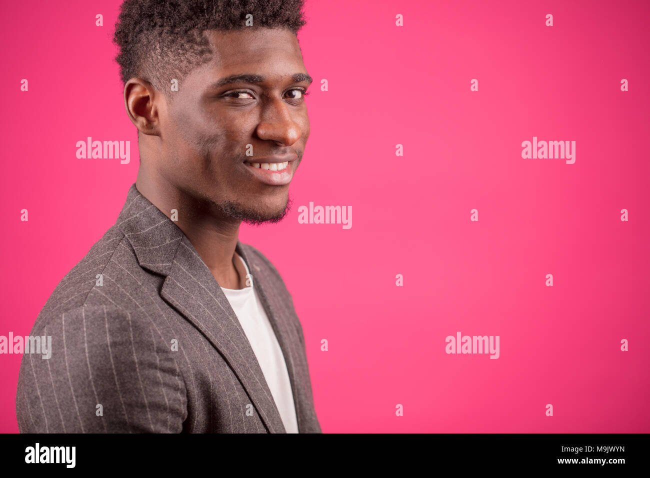 side view closeup portrait of happy Africanamerican male in grey suit ...