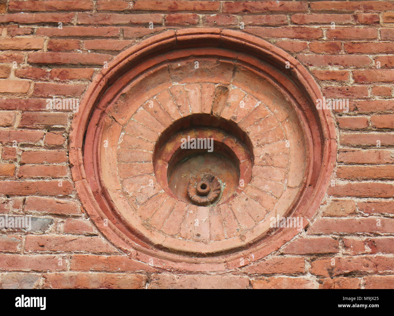 Terracotta background brick wall with a circle hole in the middle Stock ...