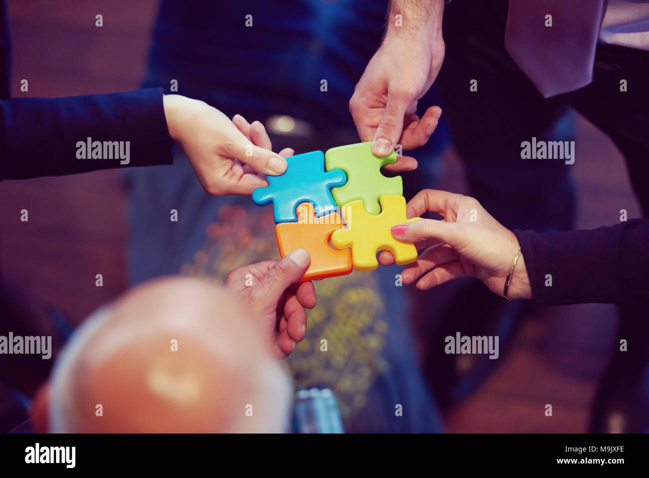 business people group assembling jigsaw puzzle and represent team ...