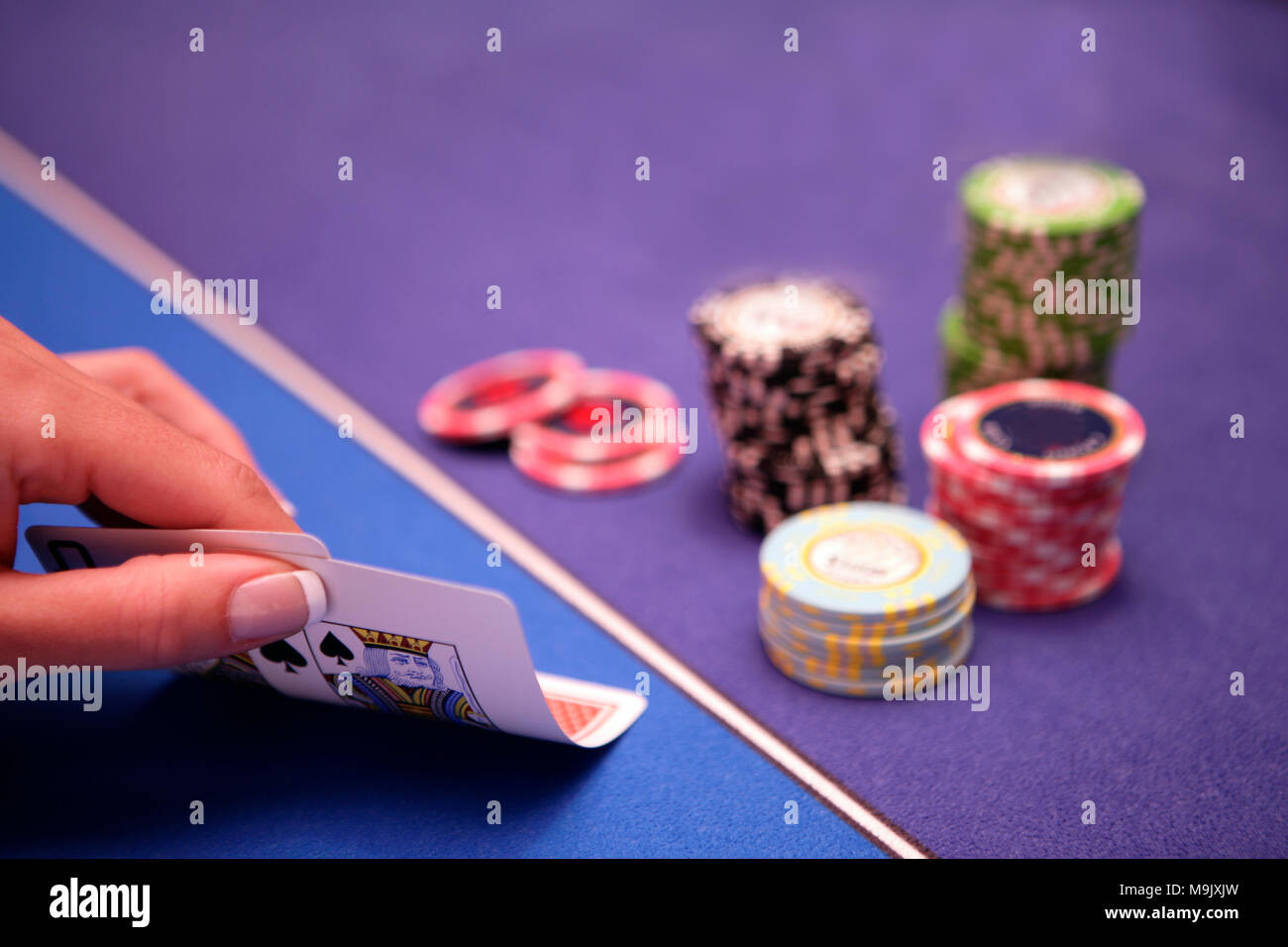 Card player checks hand Stock Photo - Alamy
