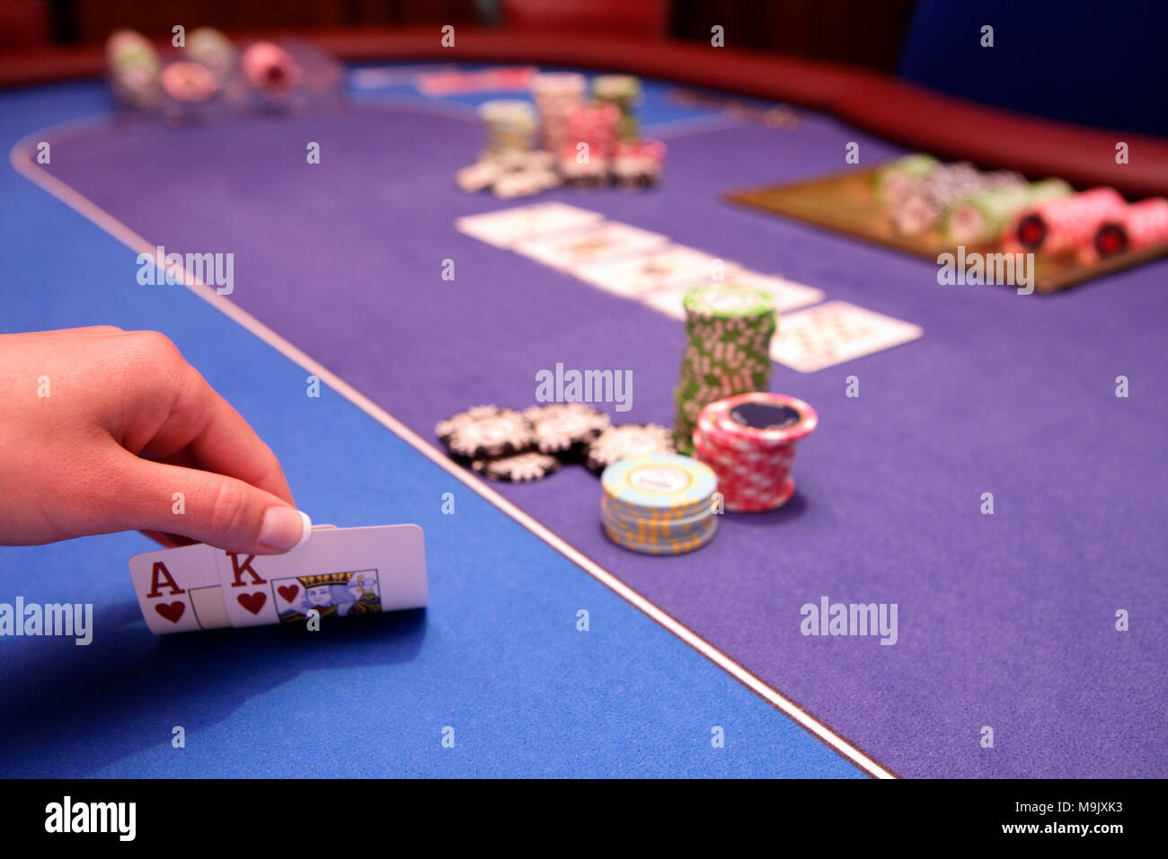 Card player checks hand Stock Photo - Alamy