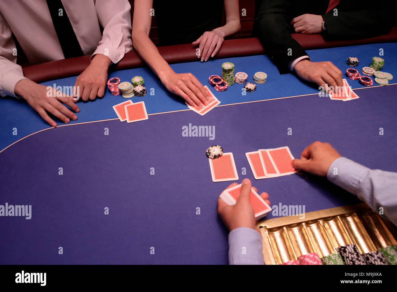 Card player checks hand Stock Photo - Alamy