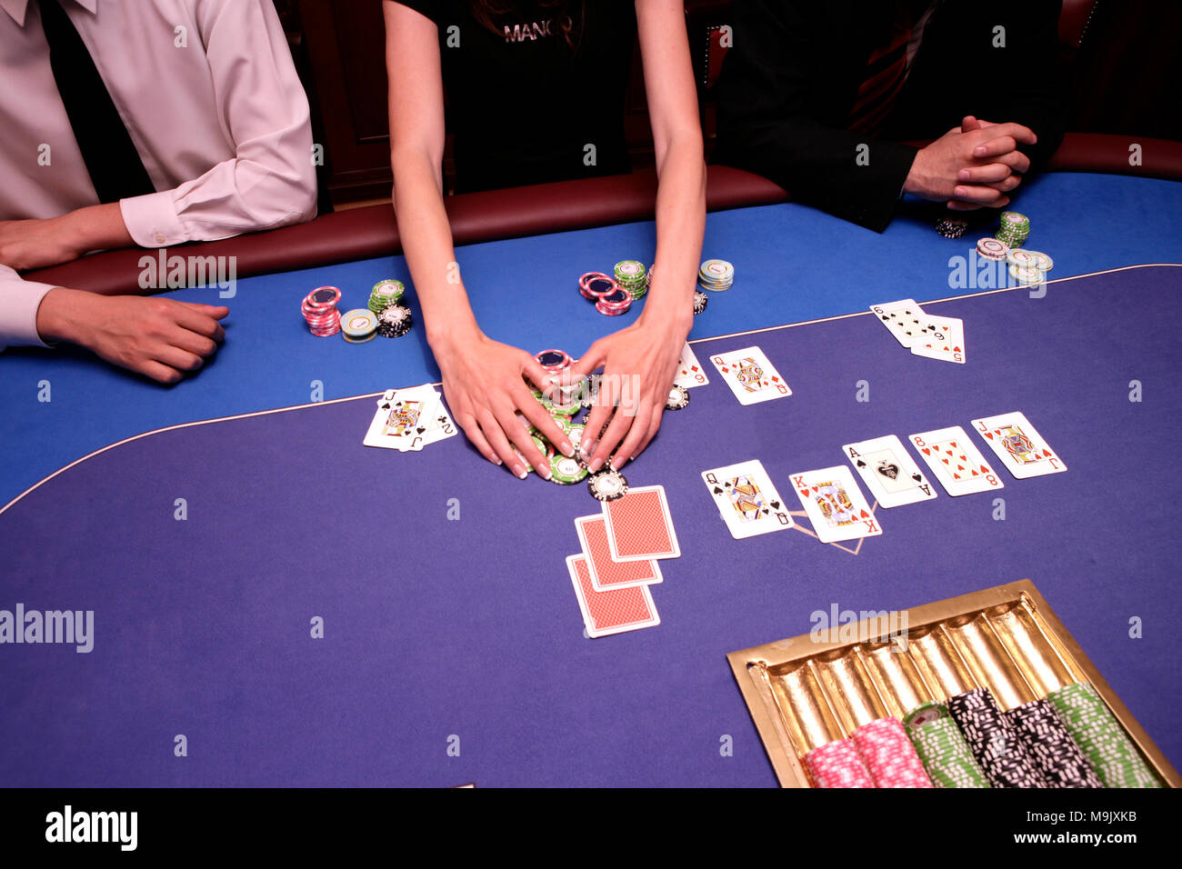 Card player checks hand Stock Photo - Alamy