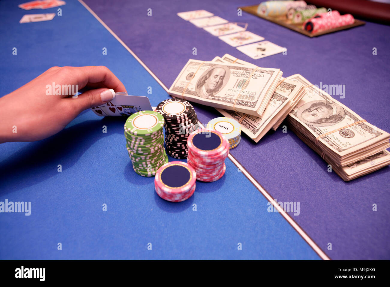 Card player checks hand Stock Photo - Alamy