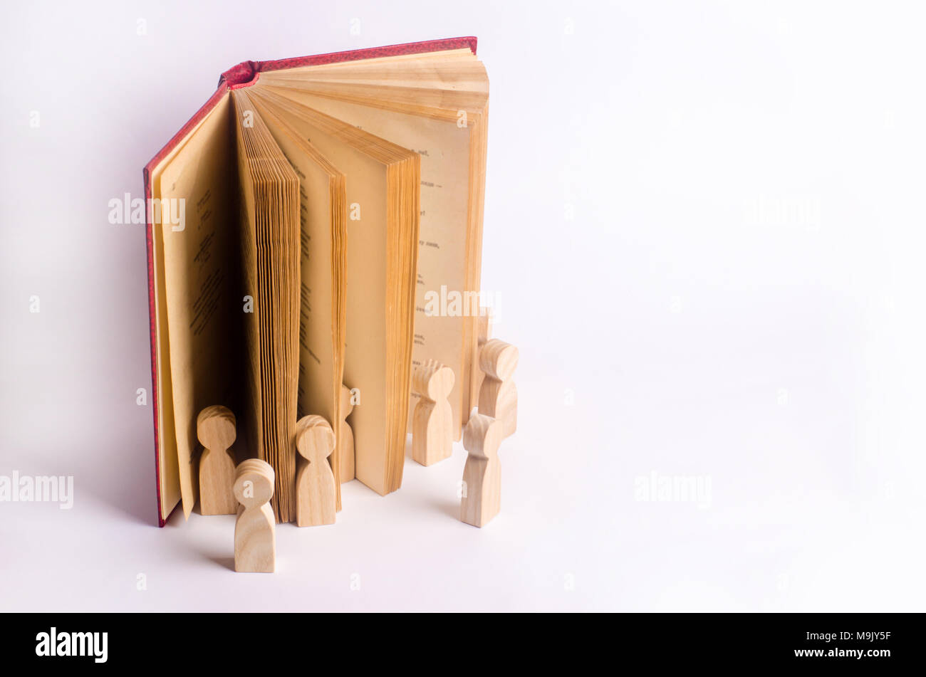 Miniature figures of people come out of the book into the real world ...