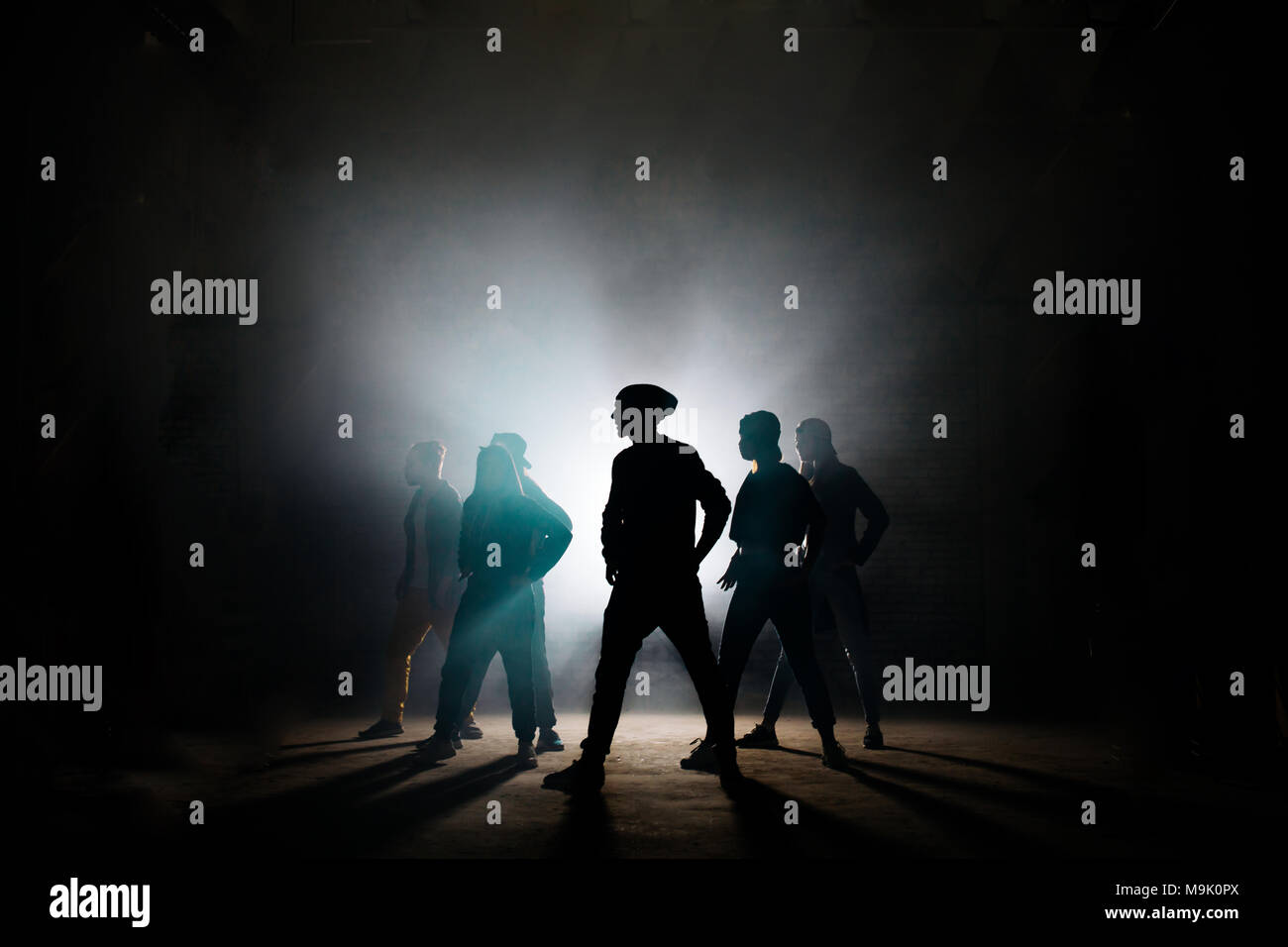 silhouette of group breakers dancing headed by leader on stage Stock ...