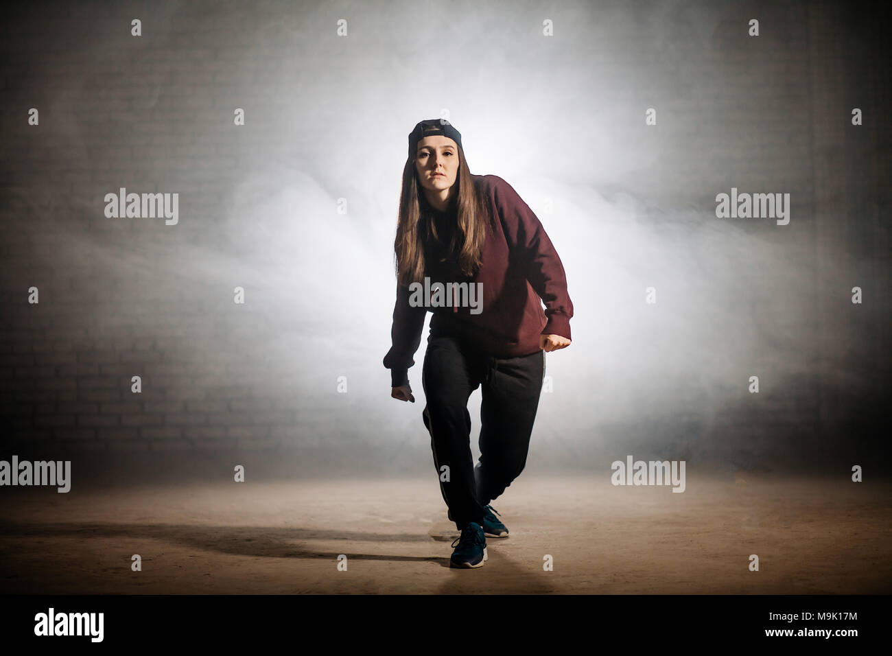 girl wearing sports clothers doing move with semi-sitting position ...