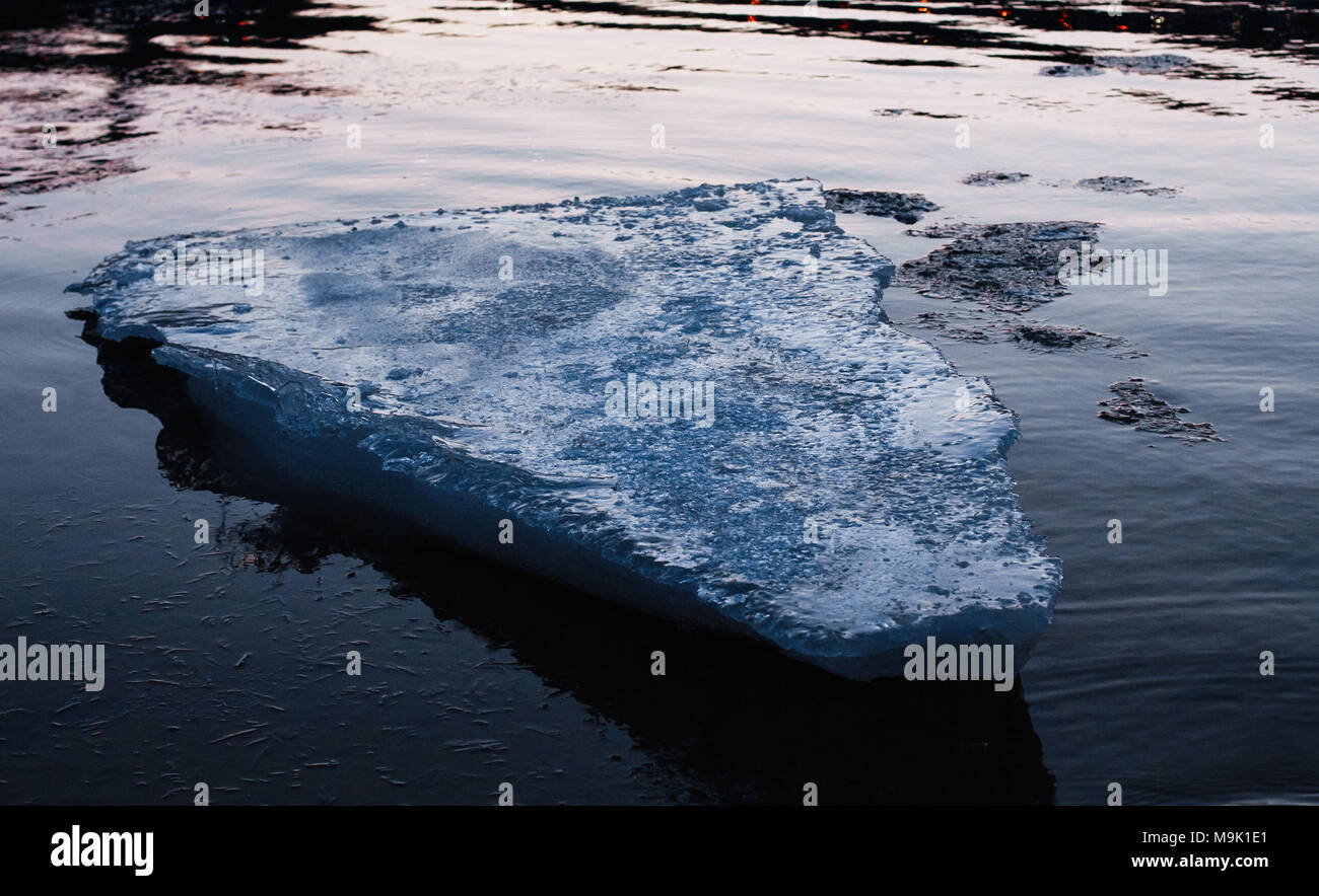 Blue melting ice block floating in the river Stock Photo - Alamy