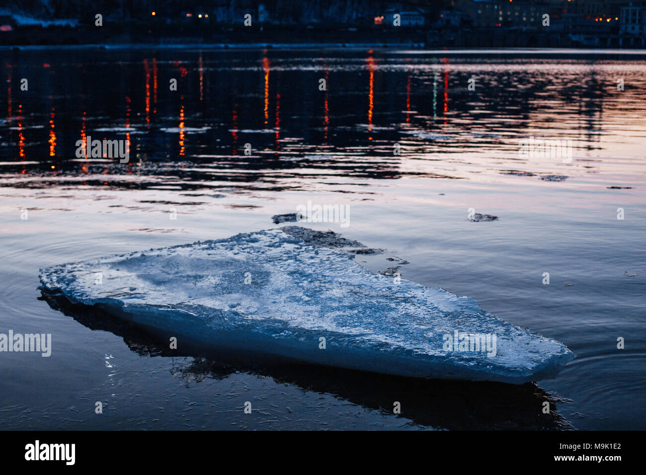 Blue melting ice floe floating in the river in the city Stock Photo - Alamy