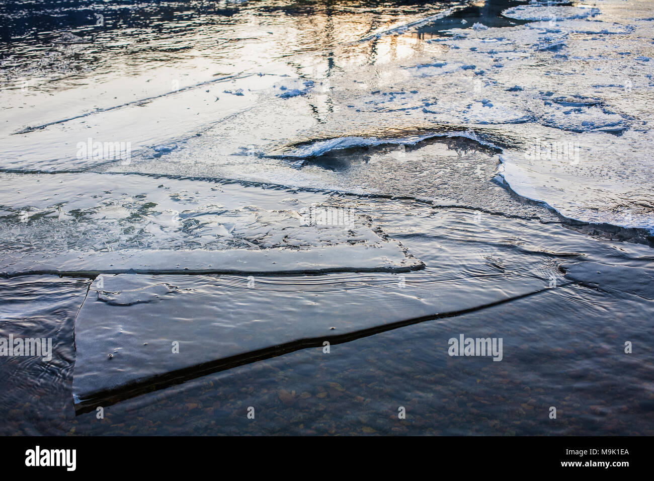 Frozen river surface covered with melting ice Stock Photo - Alamy