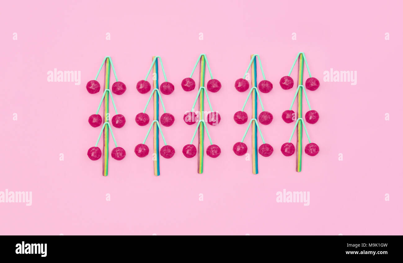 Assorted colored lollipops on pink background Stock Photo - Alamy