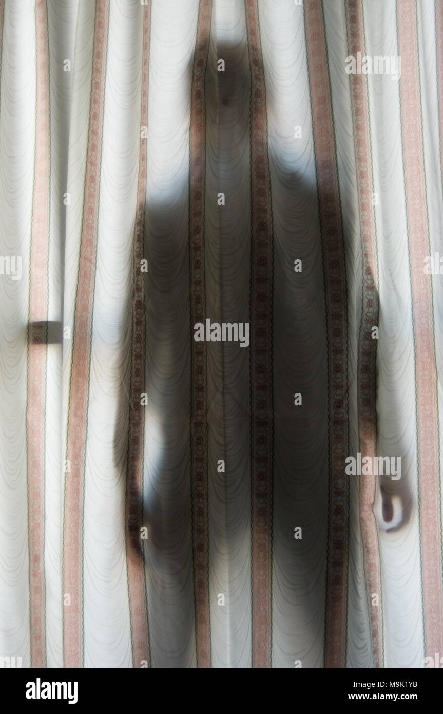 Silhouette of a man behind a curtain abreast Stock Photo - Alamy