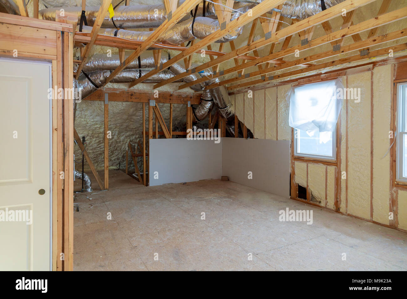 A room at a newly constructed home is sprayed with liquid insulating ...