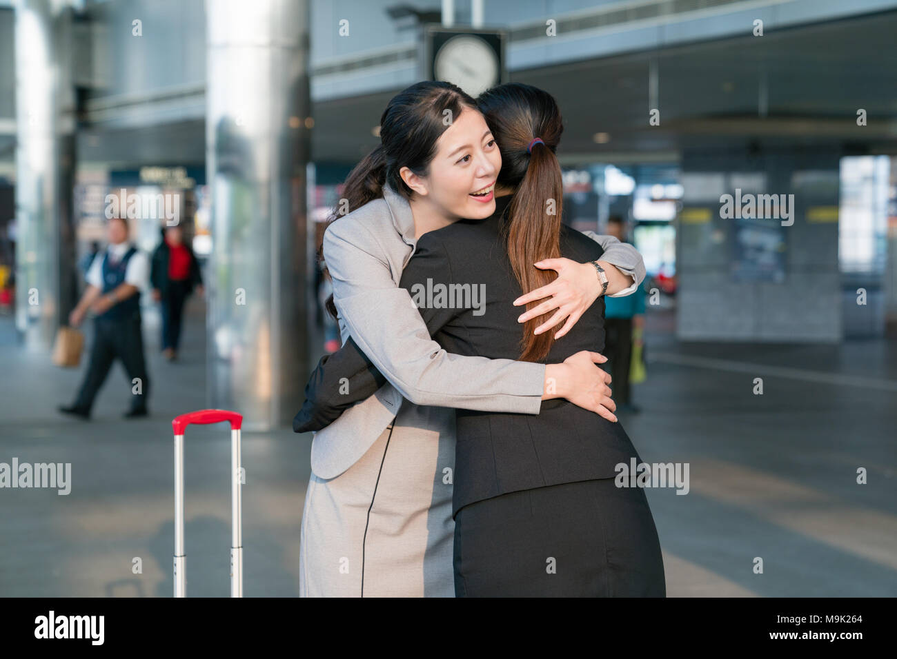 The happy meeting of two friends hugging in the station Stock Photo - Alamy