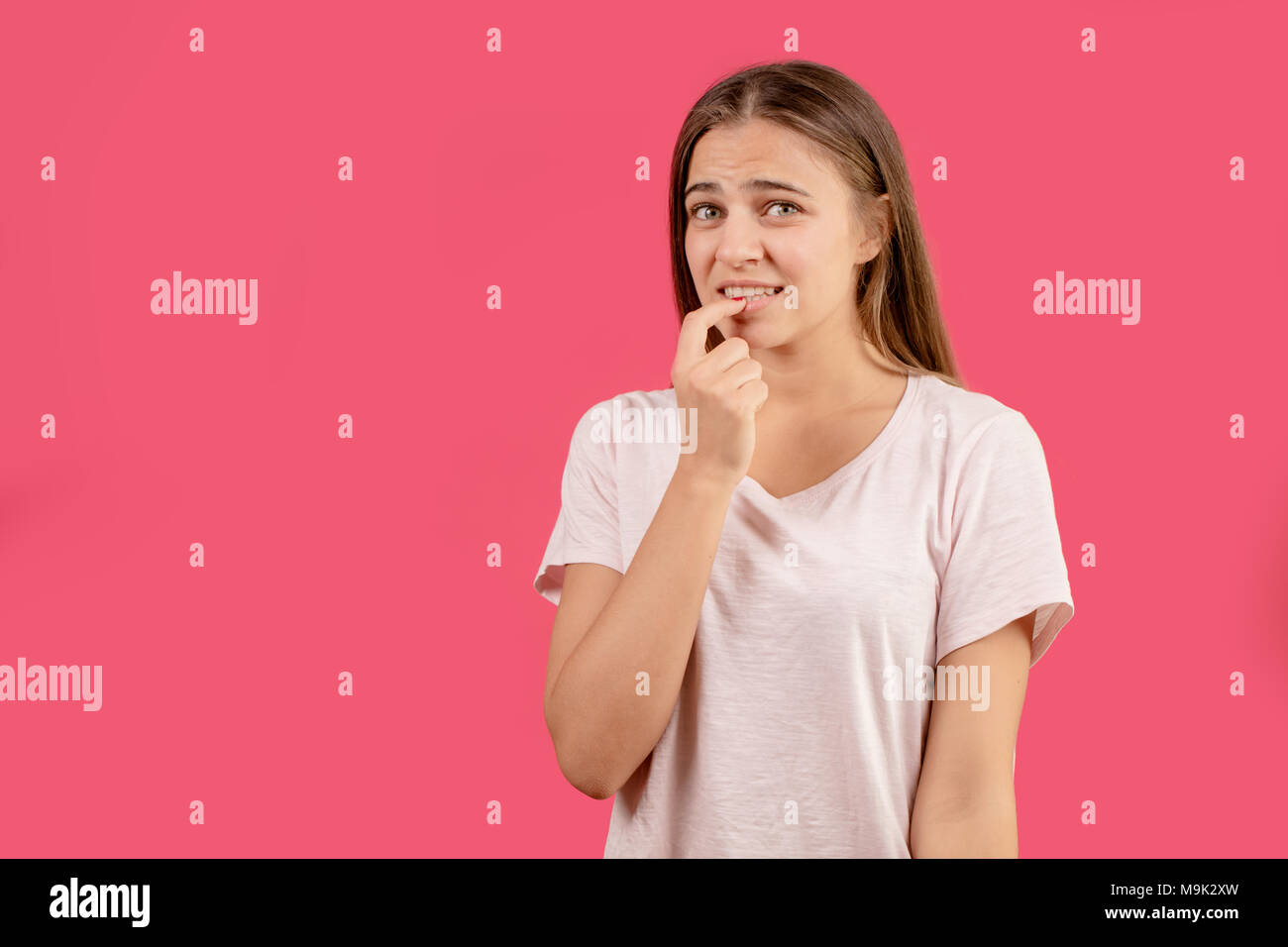 Close up photo of girl with long hair touching her aching teeth. bad ...