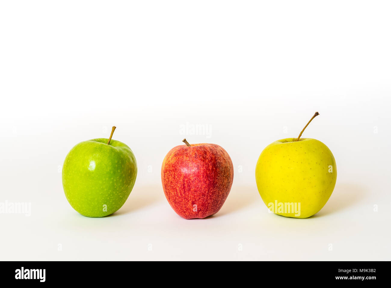 Three different coloured fresh apples isolated on white background ...