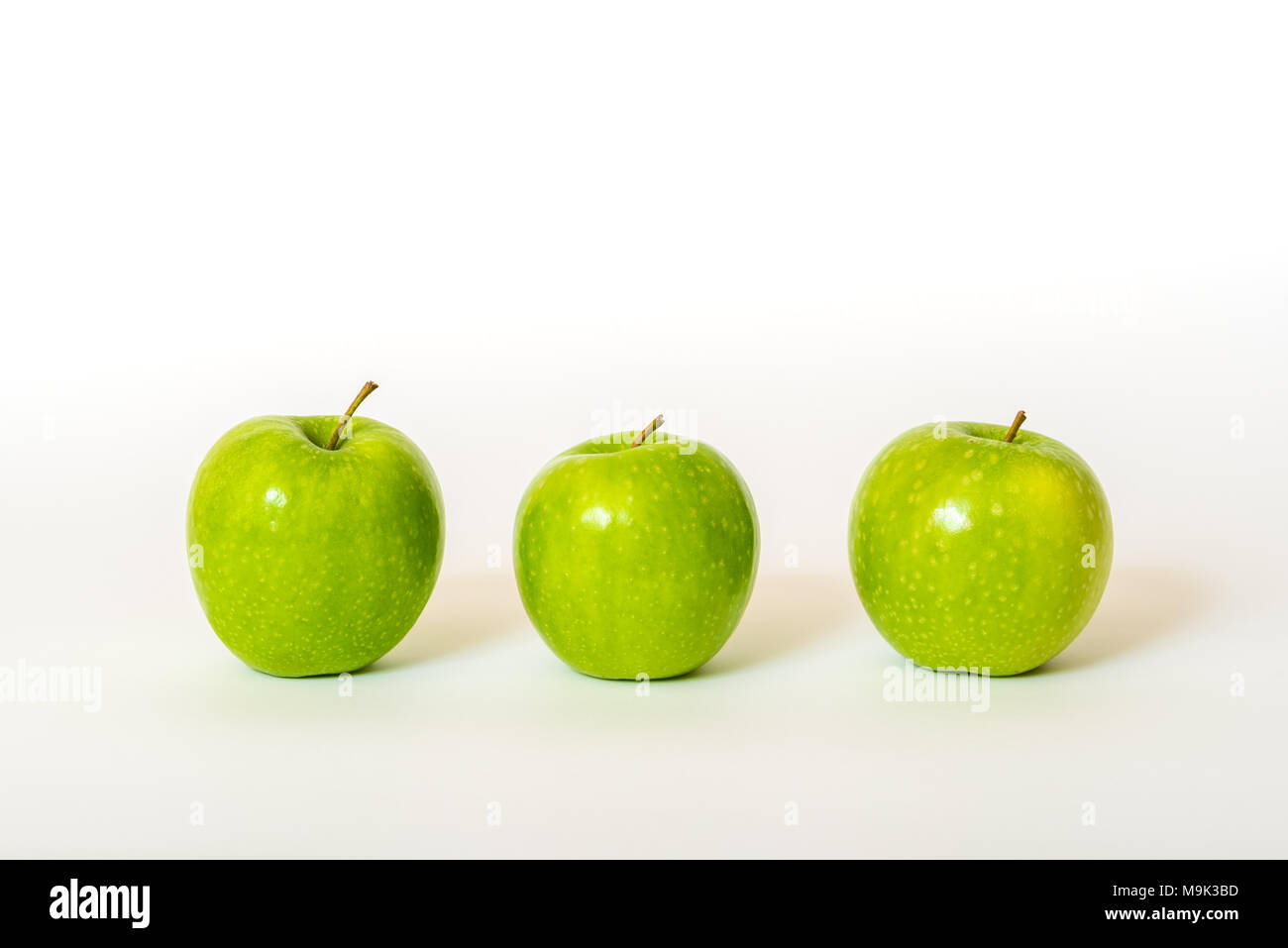 Three fresh green apples isolated on a white background Stock Photo - Alamy