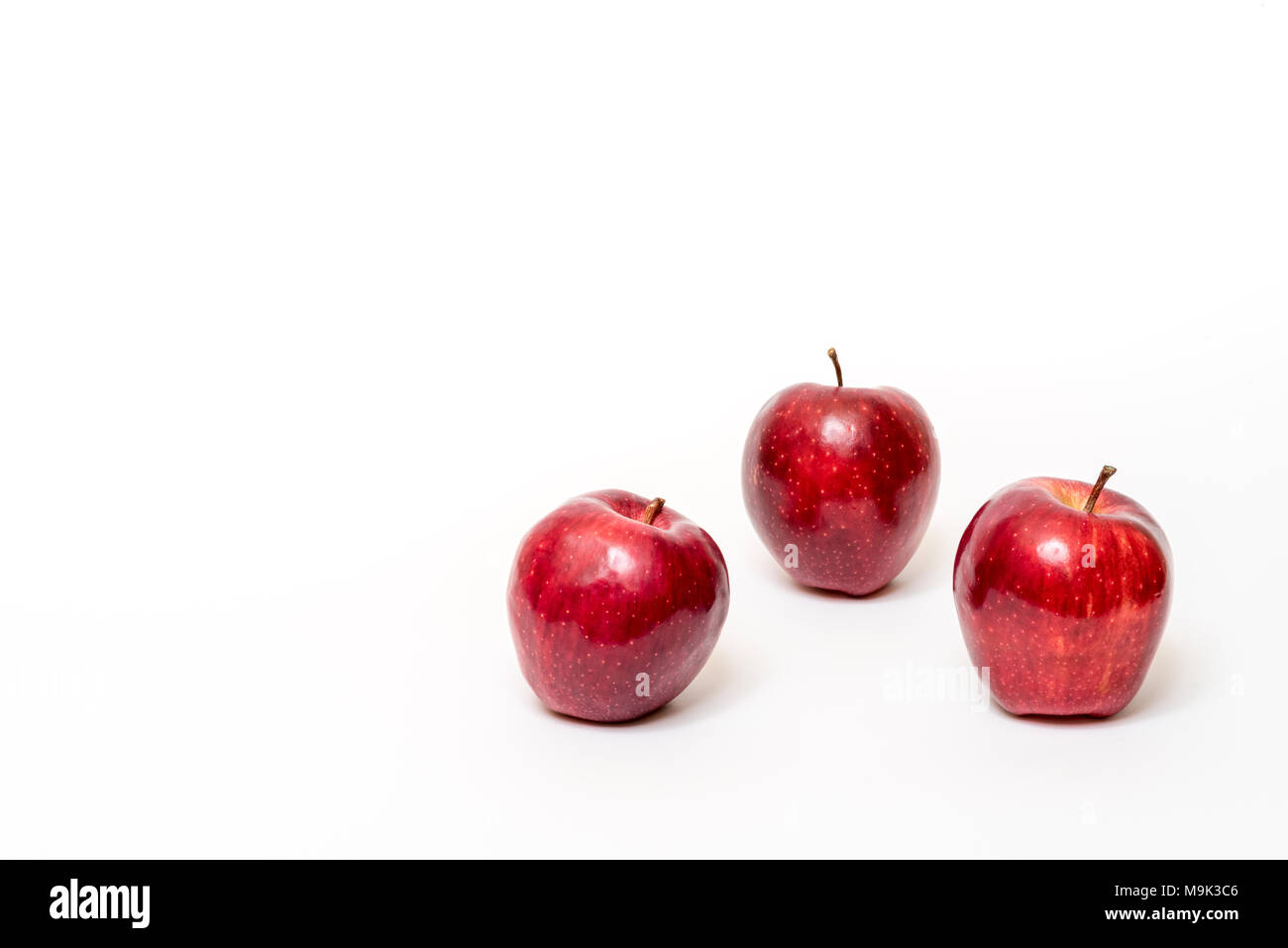 Three fresh red apples isolated on a white background with copy space ...