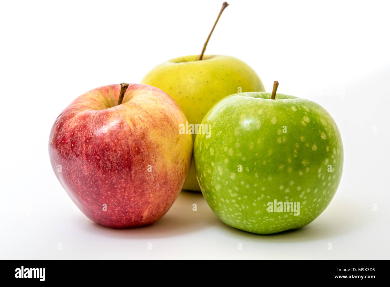 Three different coloured fresh apples isolated on white background ...