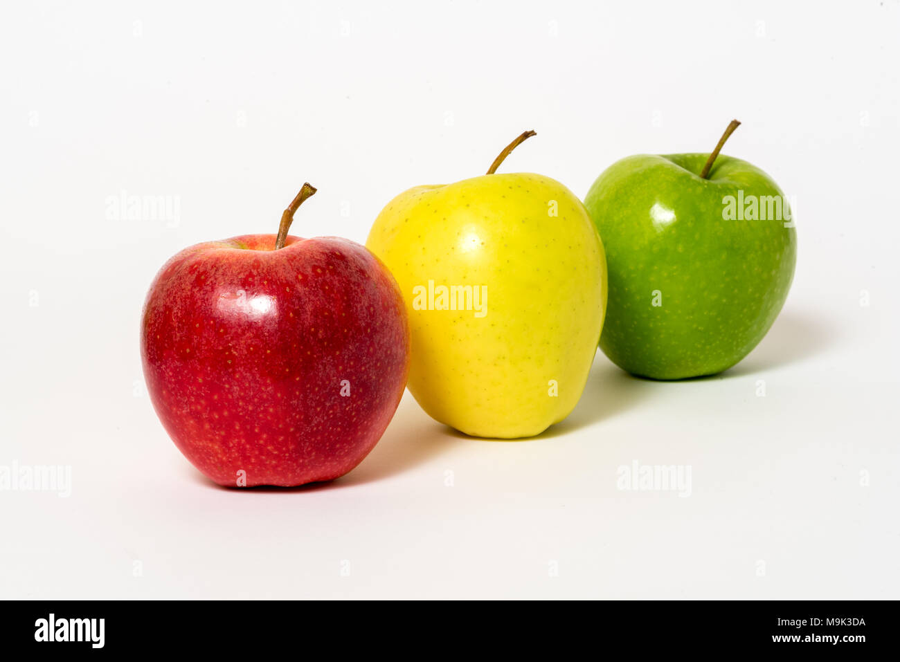Three different coloured fresh apples isolated on white background ...