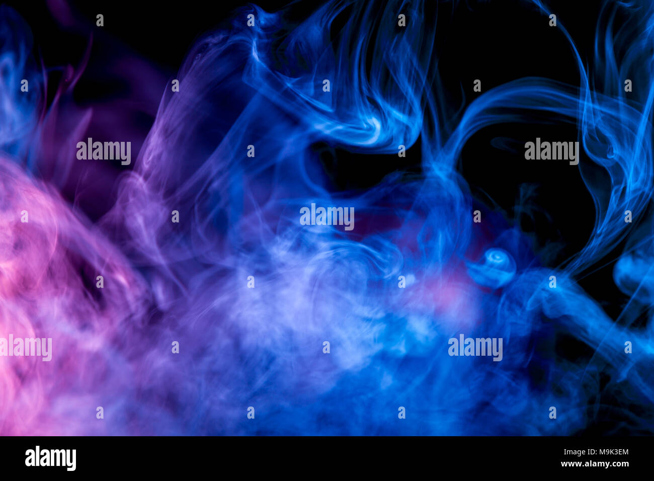 Colorful blue smoke on a black isolated background. Background from the ...