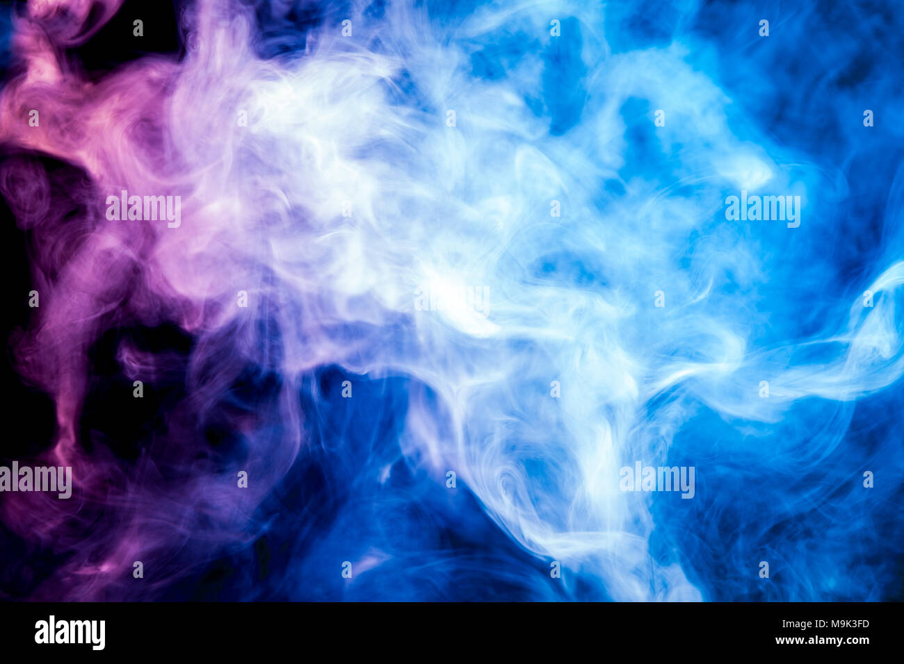 Colorful blue smoke on a black isolated background. Background from the ...