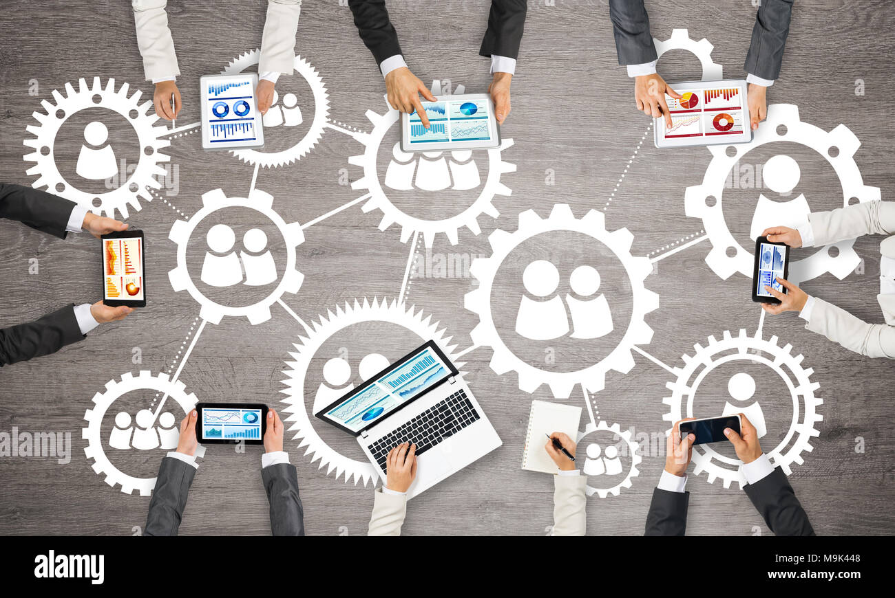 Group of people with devices in hands working together as symbol of ...