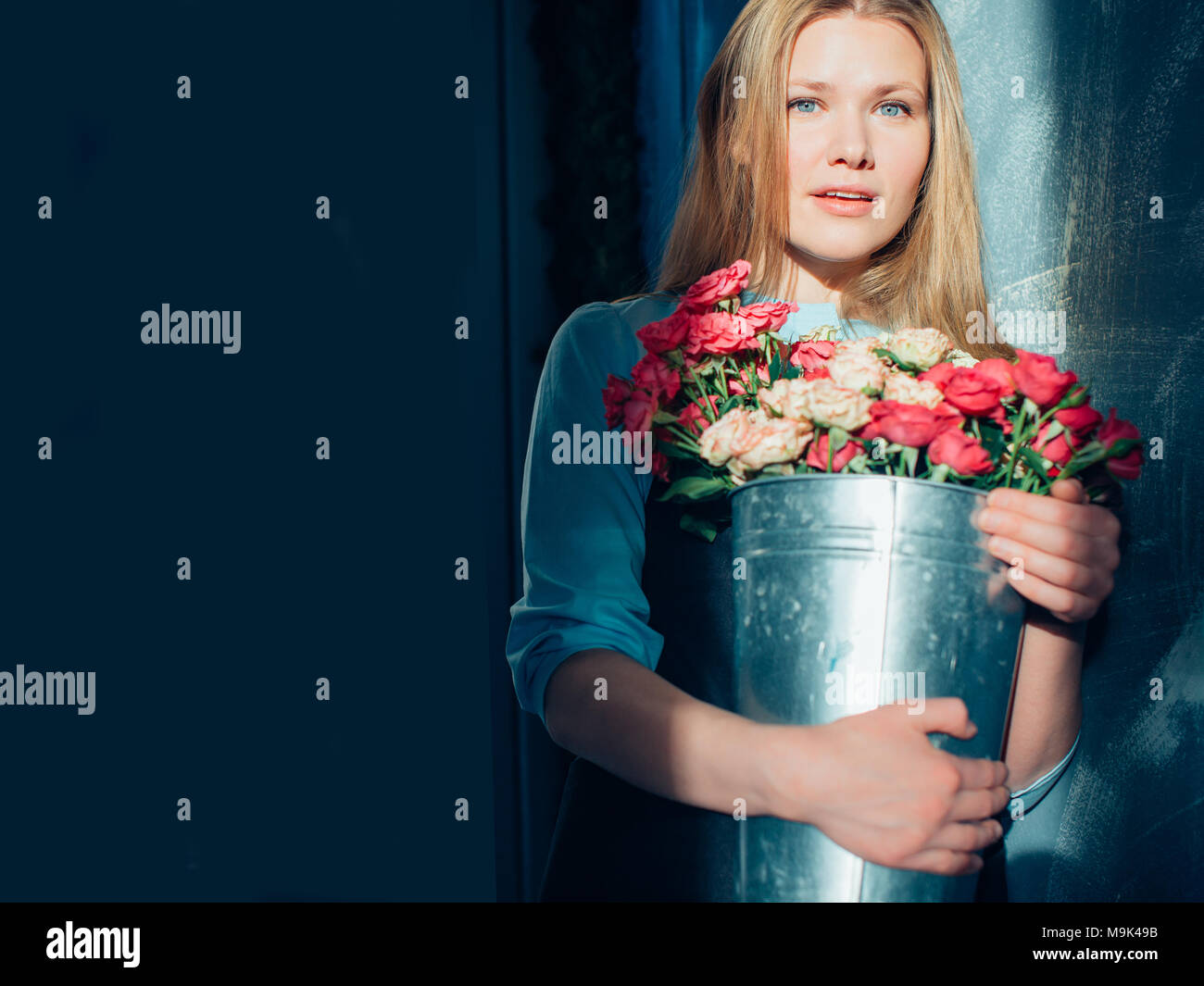 bright light falling on beautiful face of florist indoors Stock Photo ...