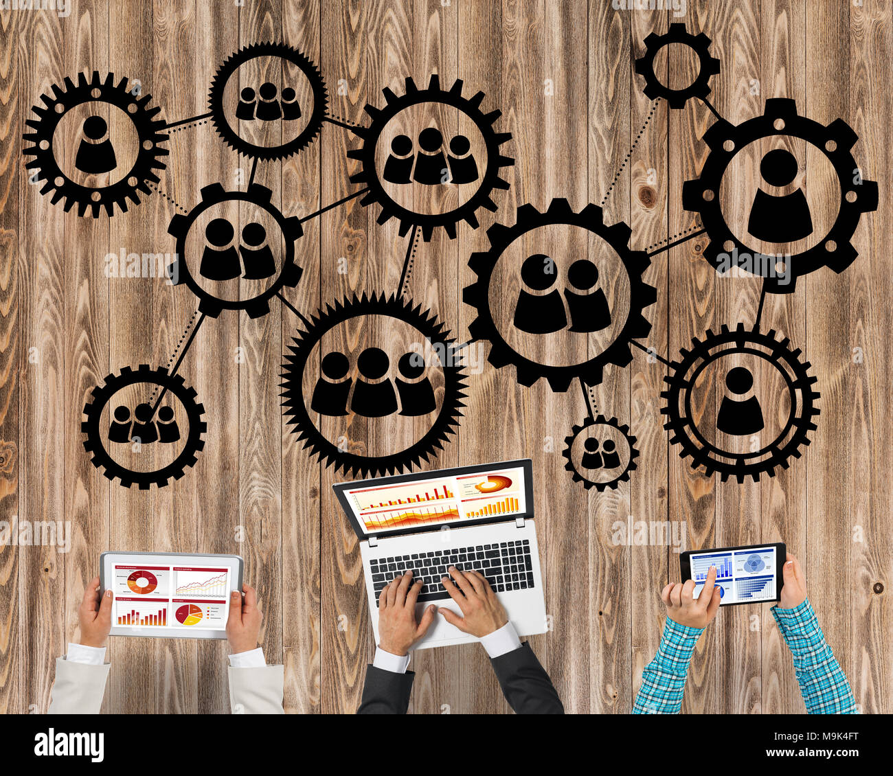 Group of three people with devices in hands working together as symbol ...
