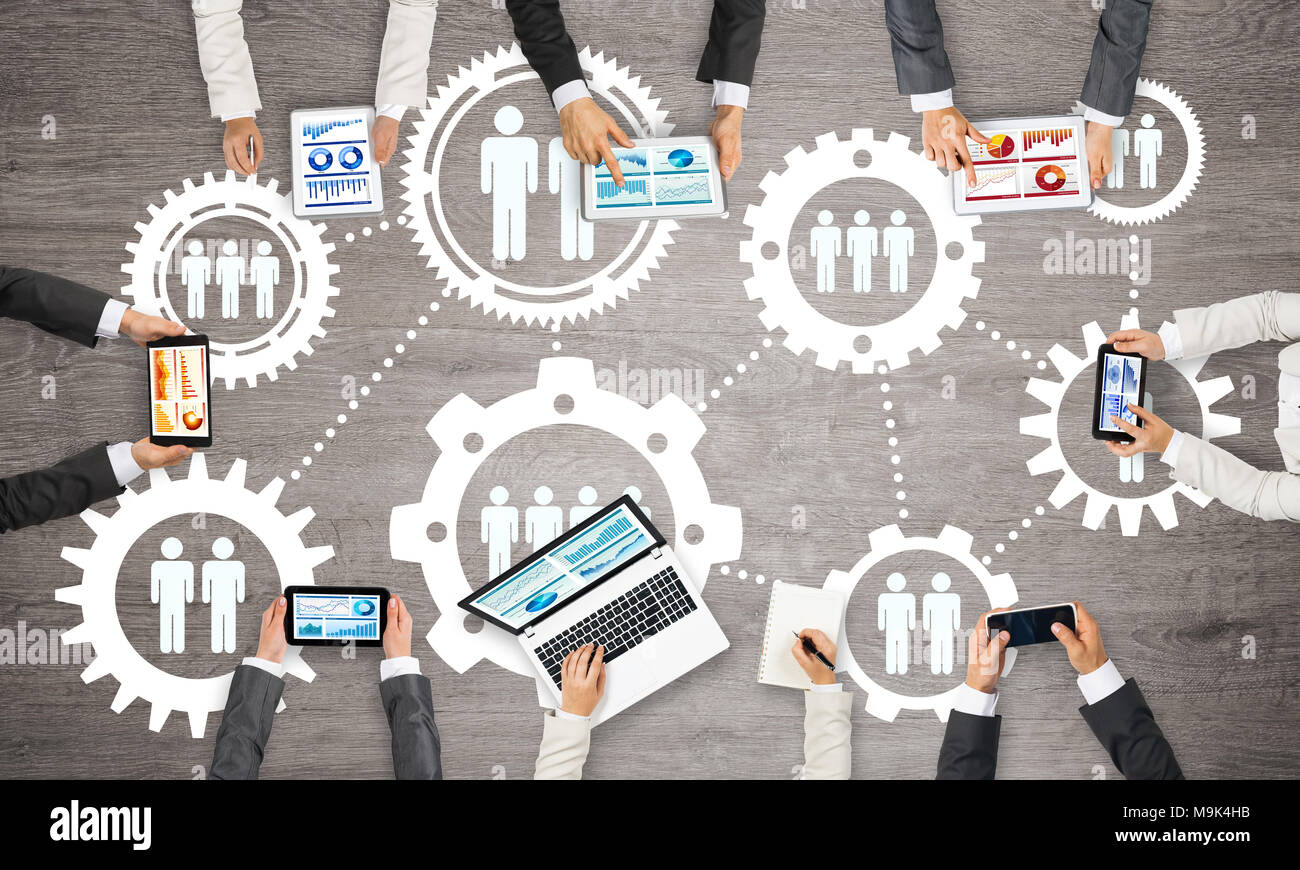 Group of people with devices in hands working together as symbol of ...