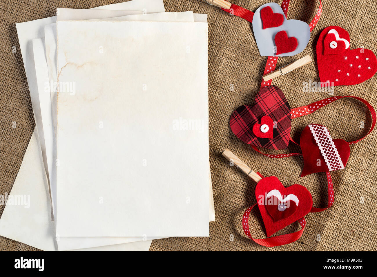 Handmade love hearts and sheets of blank paper Stock Photo - Alamy