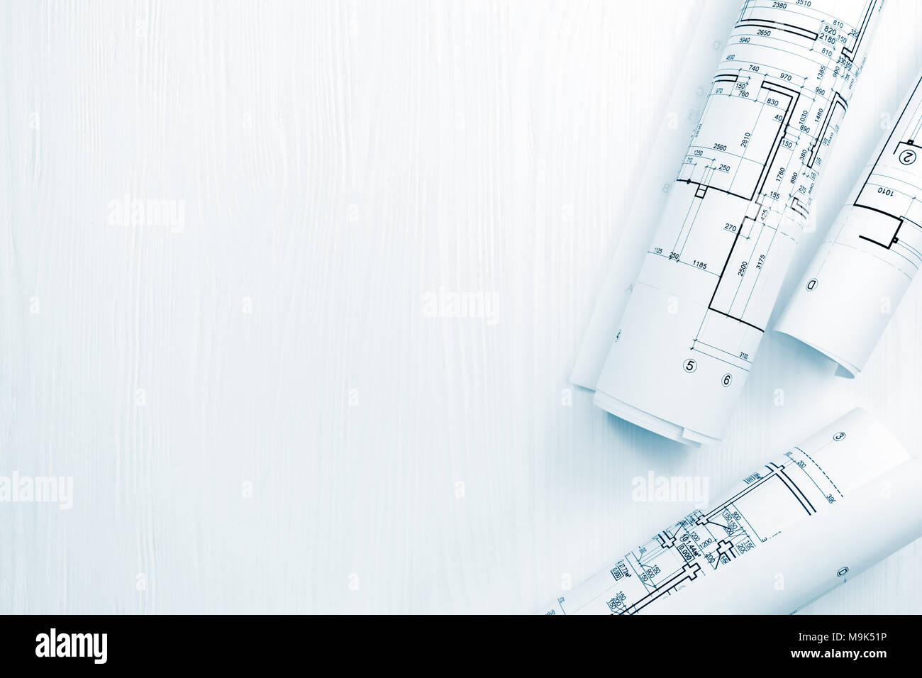 rolls of architectural plans and blueprints on architect workspace, top ...