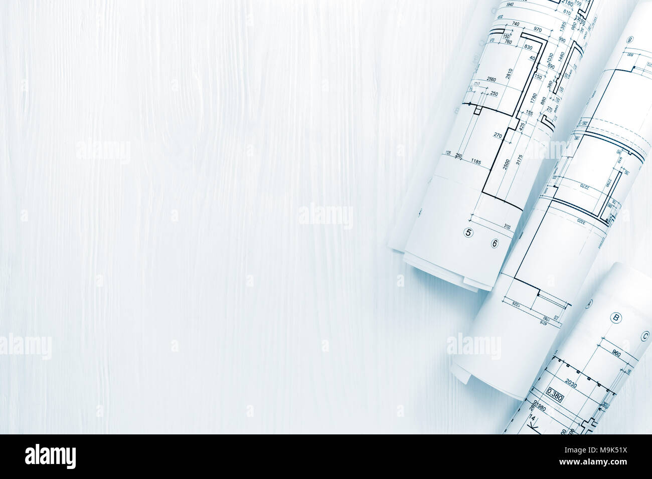 rolled architectural blueprints and engineering drawings for house ...