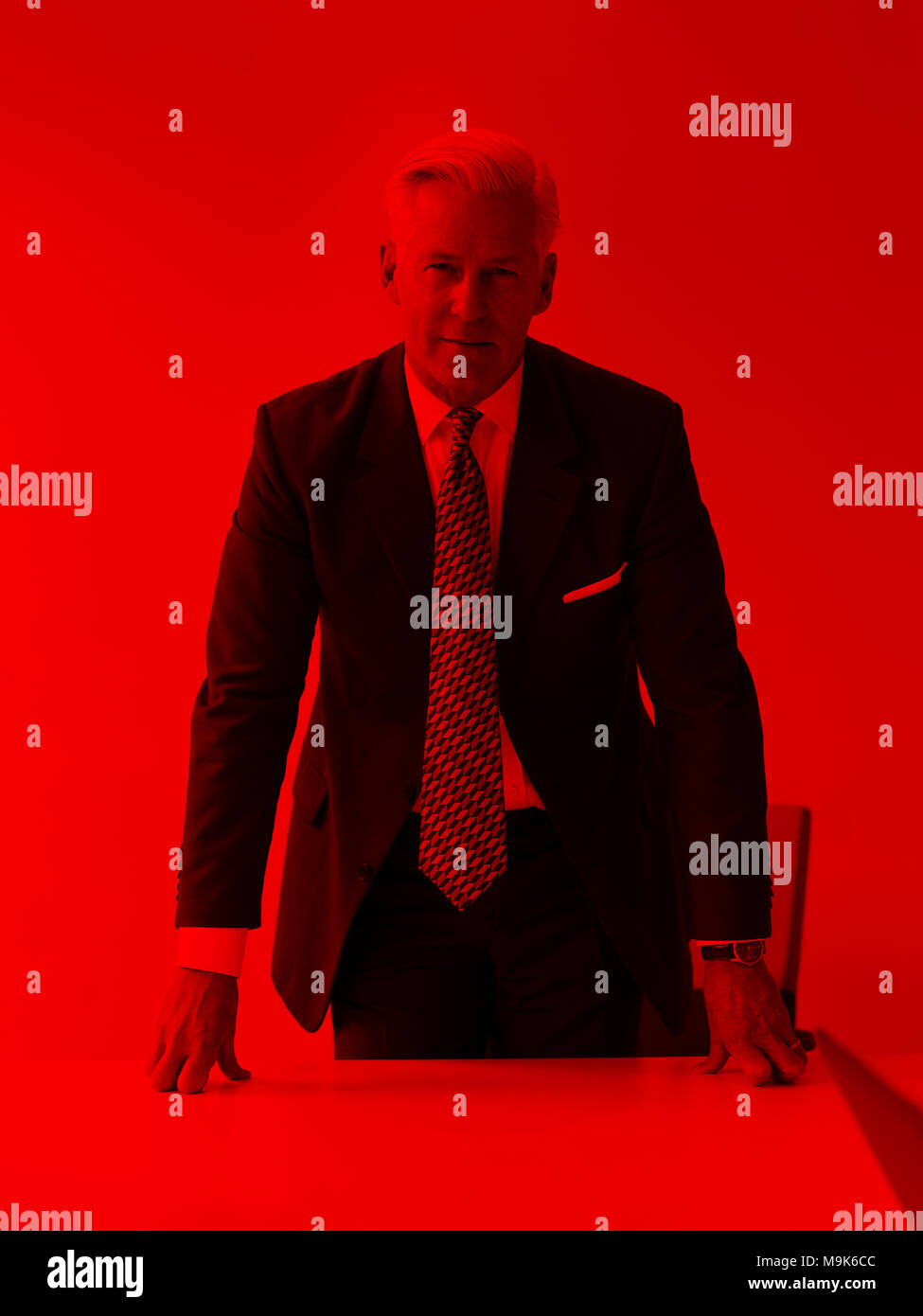 Boss sitting behind desk standing hi-res stock photography and images ...