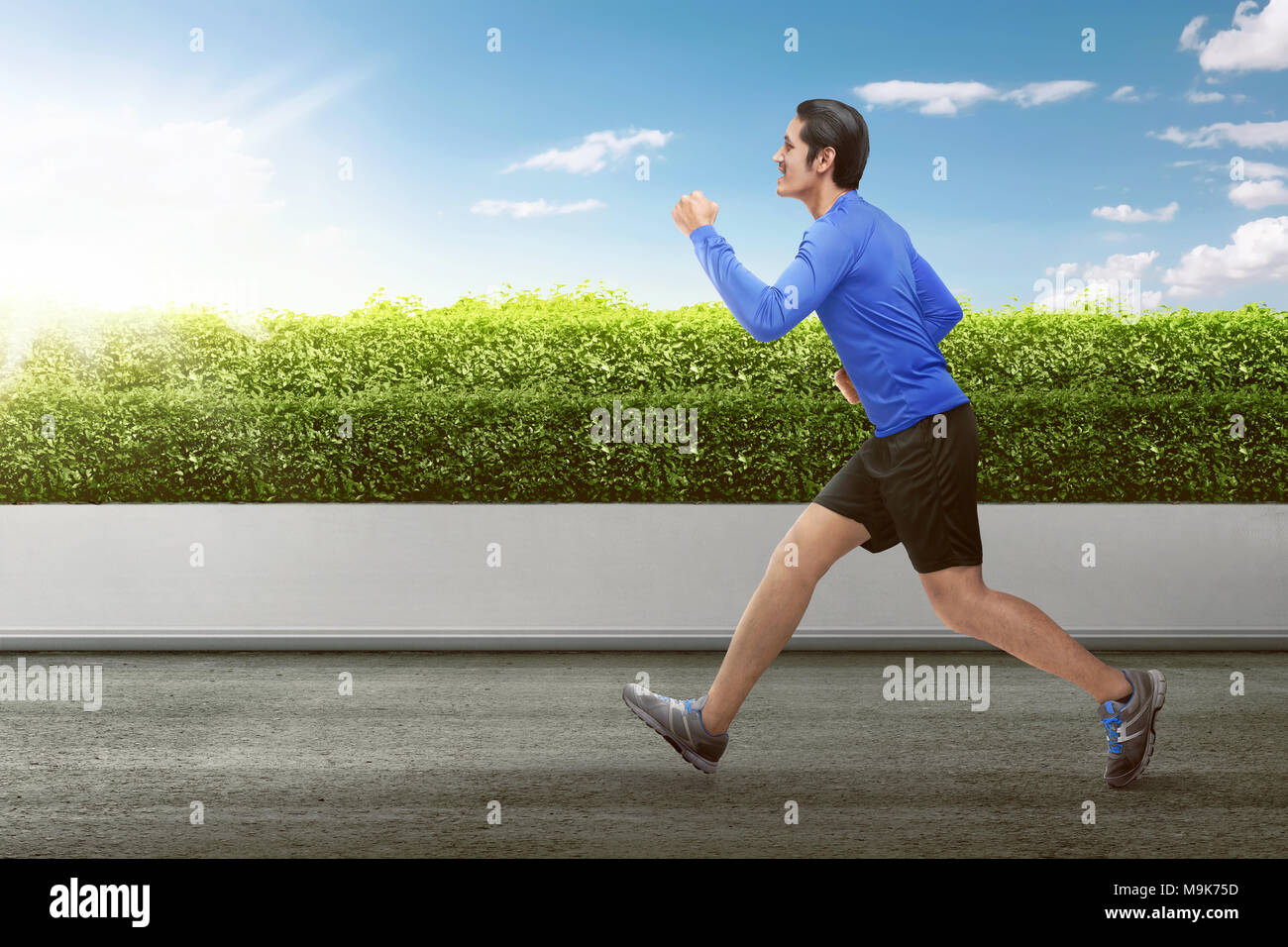 Attractive asian man running on the morning at park Stock Photo - Alamy
