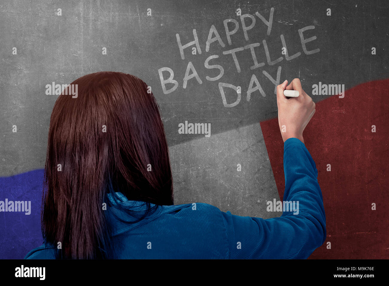 Rear view of woman writing happy bastille day on the wall. Happy ...