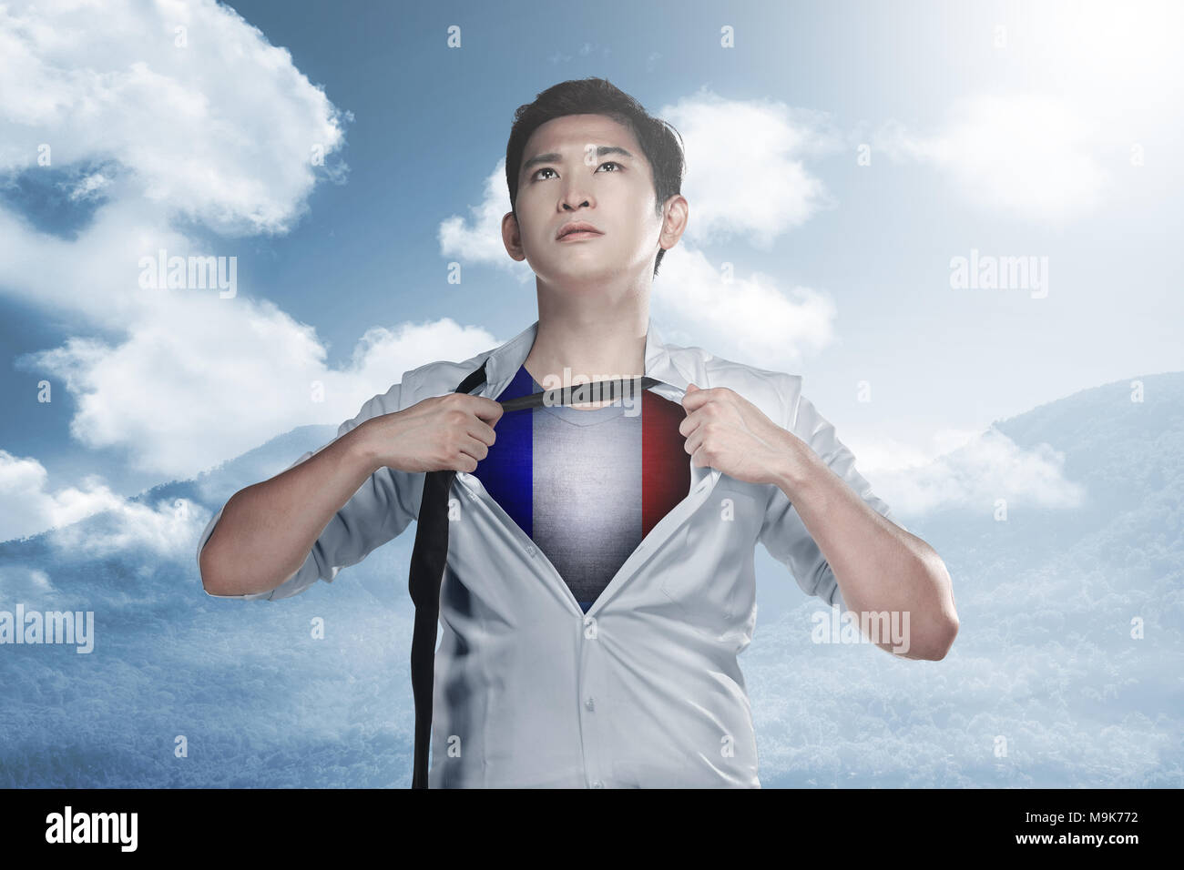 Handsome asian businessman ripped his shirt off and showing france flag ...