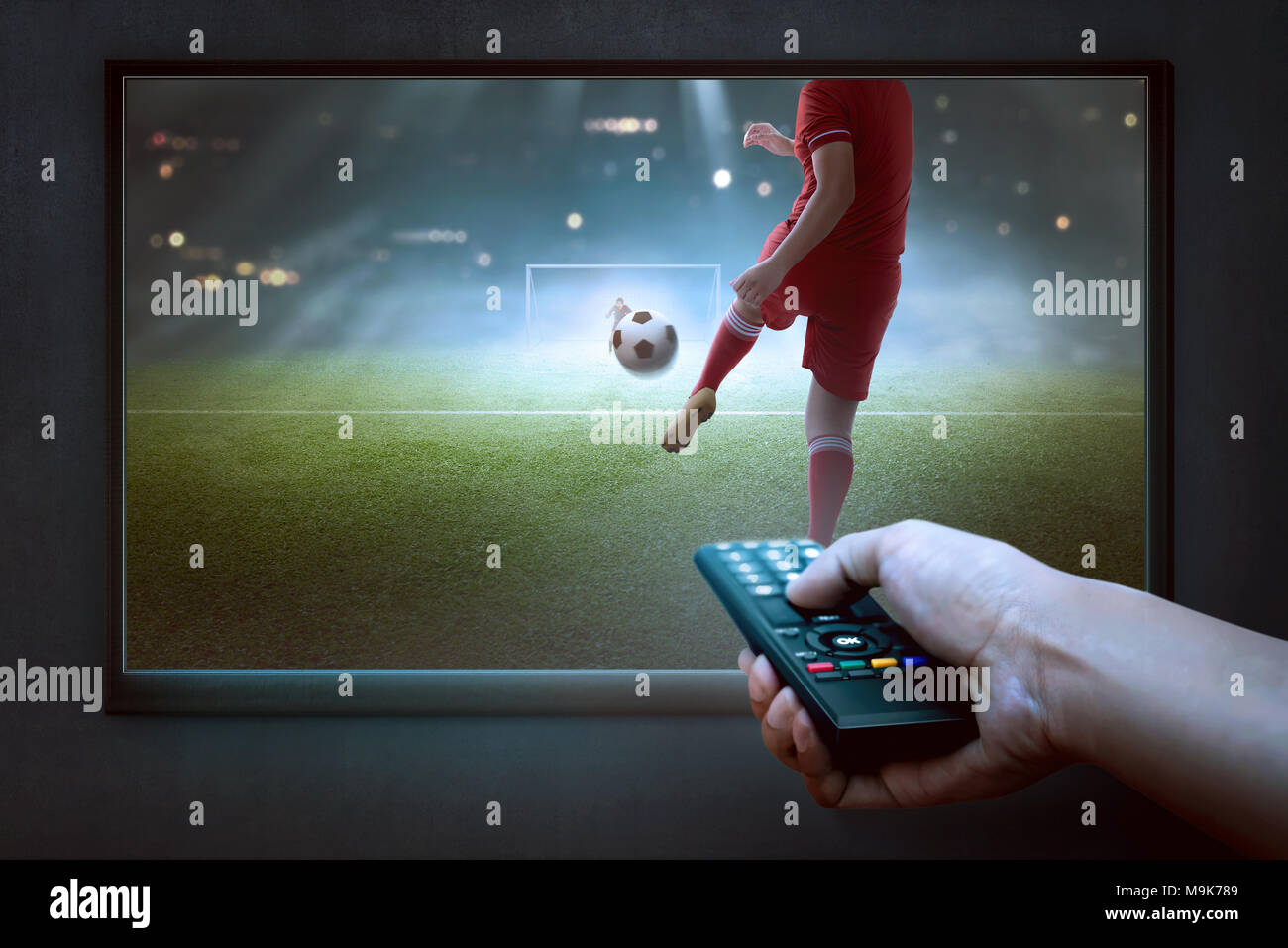 People hands with remote watching football game on the tv Stock Photo ...