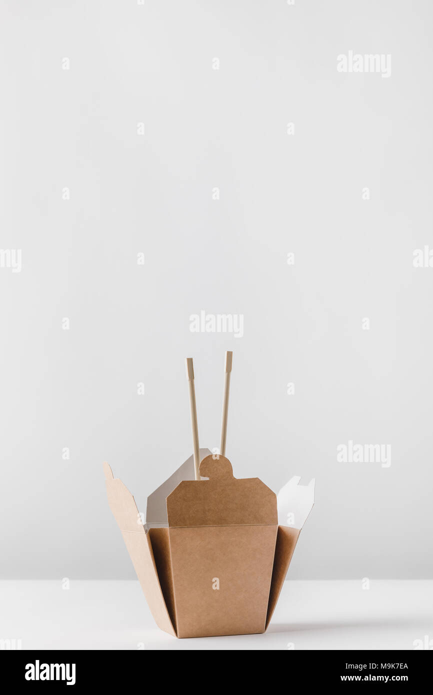 noodles box with chopsticks on white table Stock Photo - Alamy