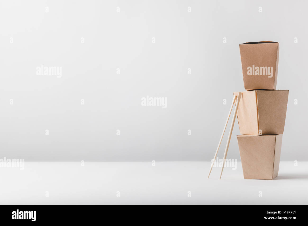 three noodles boxes with chopsticks on table Stock Photo - Alamy